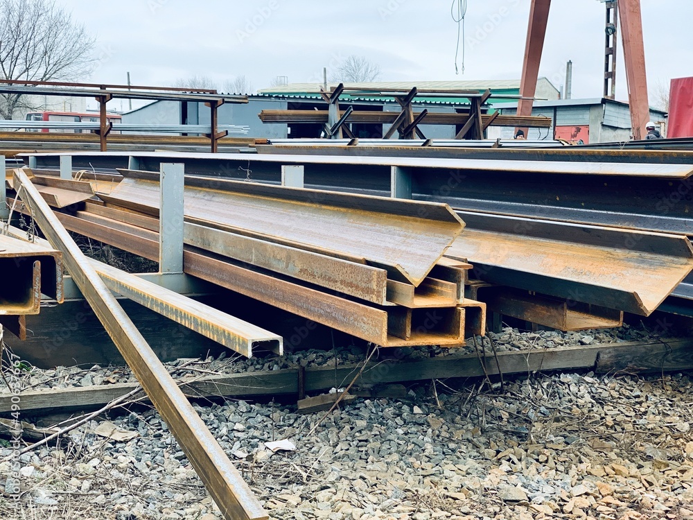 Stack of steel and rusty rail profiles. Waste production. Rail cross ...