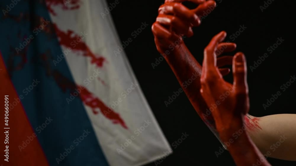 bloody hands dance against the background of the Russian flag in blood ...