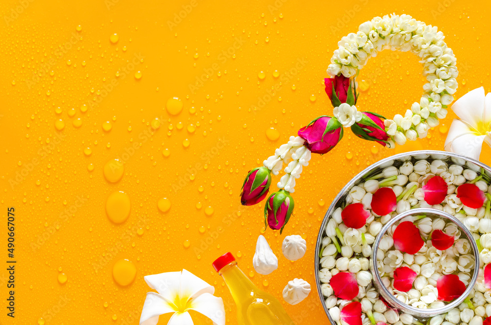 Songkran festival background with jasmine garland, flowers in water ...