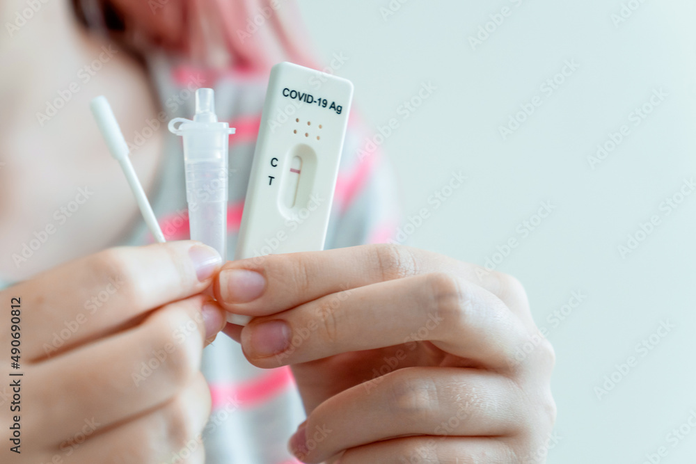 Hands holding Covid-19 rapid antigen test cassette with negative result ...