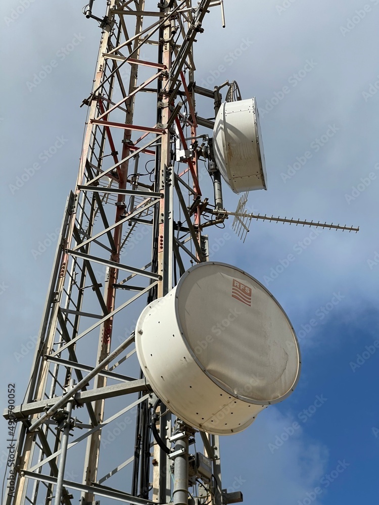 Telecommunication and mobile network infrastructure with two cell site towers side by side ...