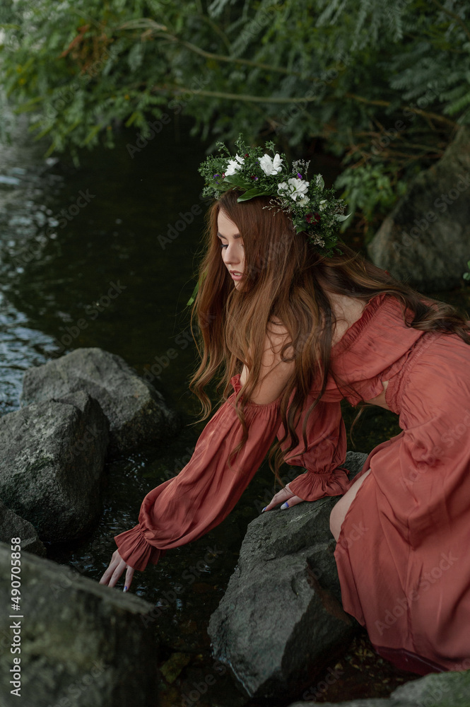 Mavka water nymph naiad near the water in nature forest on the river ...