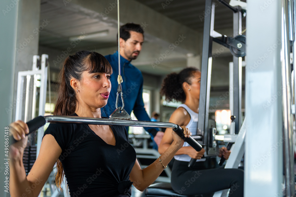 Strong woman athletic workout exercise pulling weight lifting machine ...