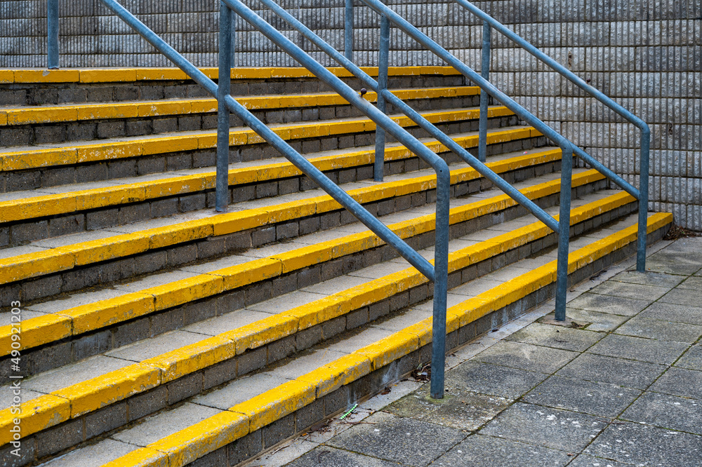 Outdoor concrete steps with yellow safety markings and handrails Stock ...