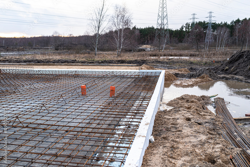 The foundation slab is made of reinforcement rods, bound with tie wire ...