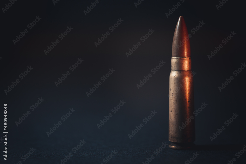 Assault rifle bullet on isolated black background. Impressive assault ...