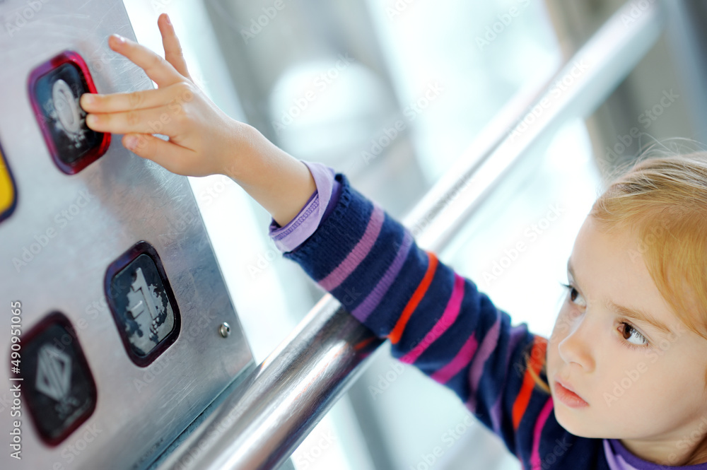 Little girl pressing elevator button with her finger. Child reaching to ...