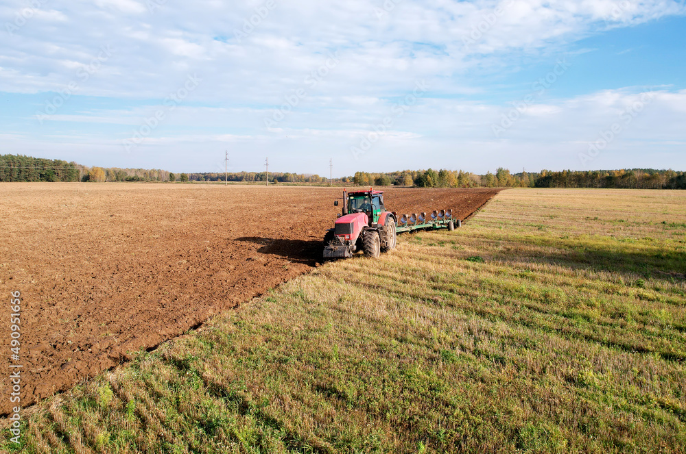 Tractor with Plough on Plowed. Ploughing and Soil Tillage. Agricultural ...