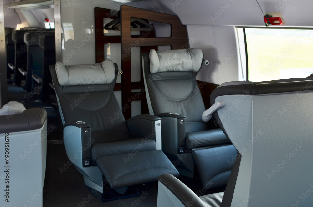 Seats in the cabin of business class carriage of a passenger high speed ...