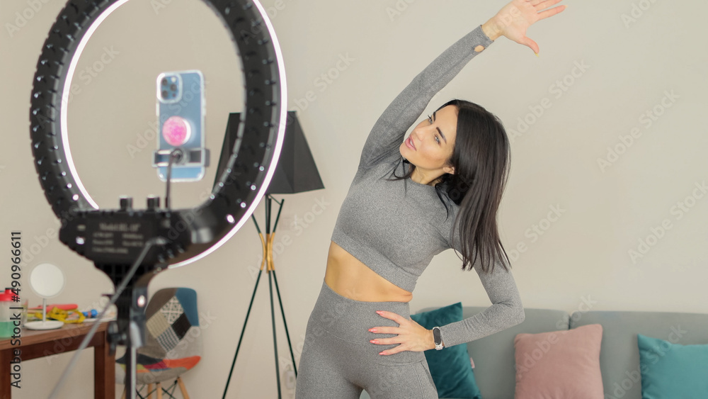 Virtual online fitness. Woman virtual workout at home living room ...