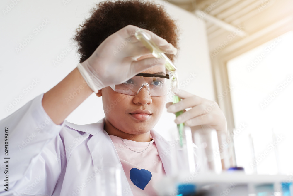 Smiling African black girl student is study and test for chemical and ...
