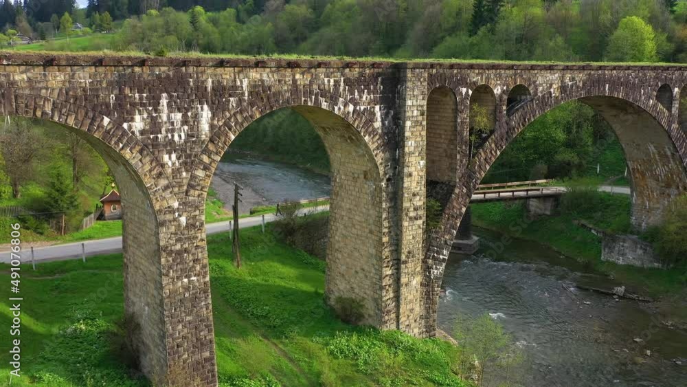 stone arched railway bridge over the Prut River in the Carpathians in ...