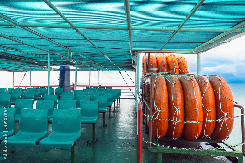 Orange inflatable lifeboats on ferry deck for emergencies and maritime ...