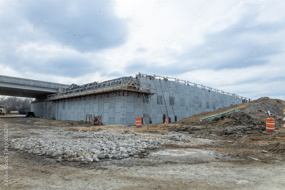 Road construction work site. Retaining wall construction with highway ...