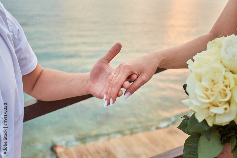 graceful touch of the hands of the bride and groom. Wedding ceremony ...