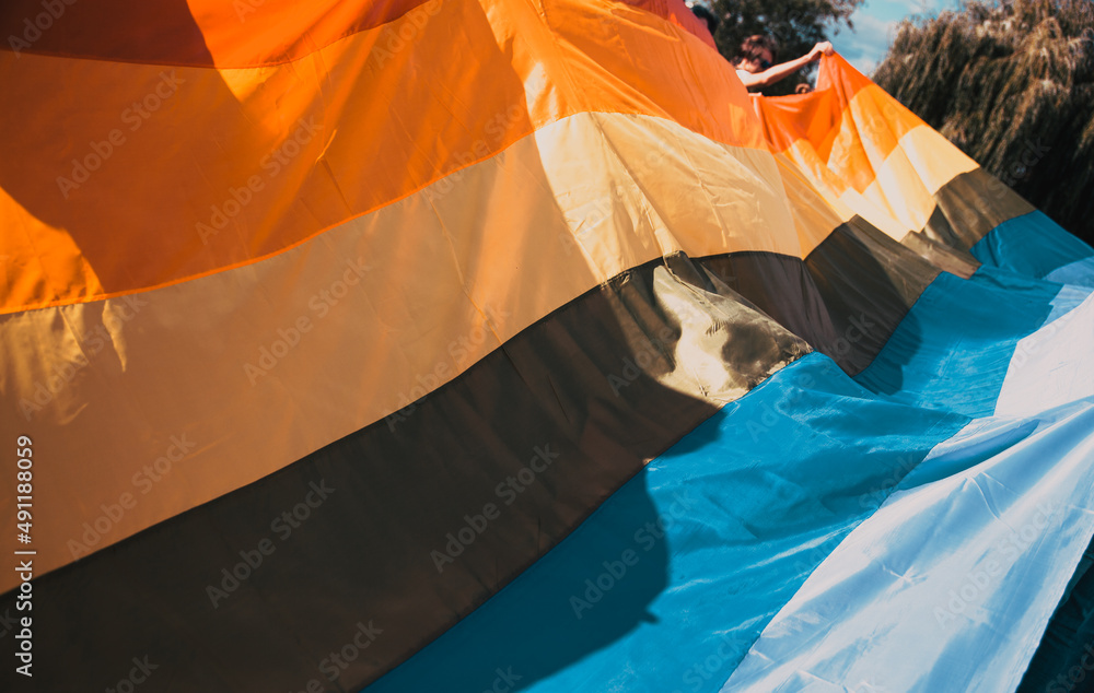 people holding giant rainbow flag at pride parade - LGBT symbol Stock ...