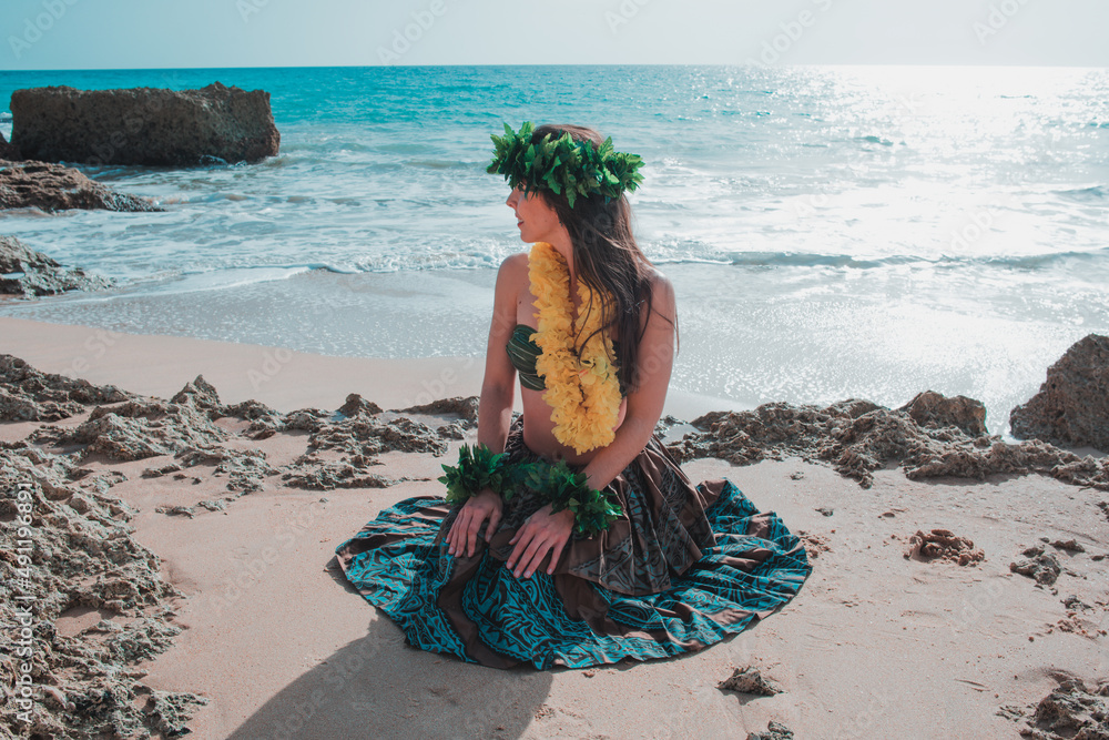 Hawaii dancer. Hula dancer woman unrecognizable on the beach sitting on ...