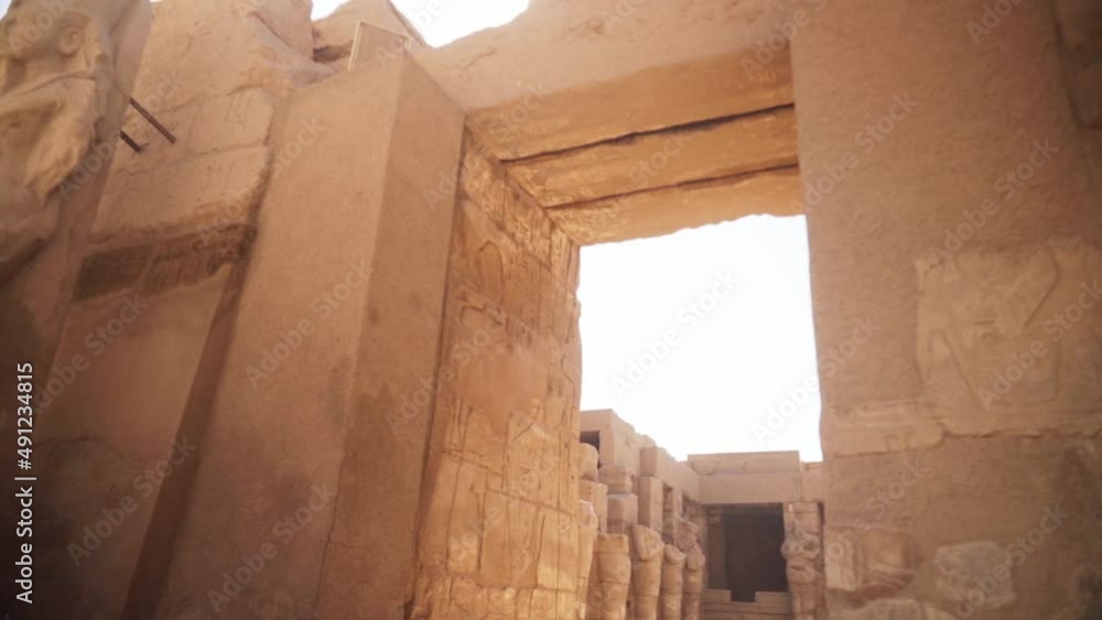 Outside of the tall entry way into the Kamak Temple with carved details ...
