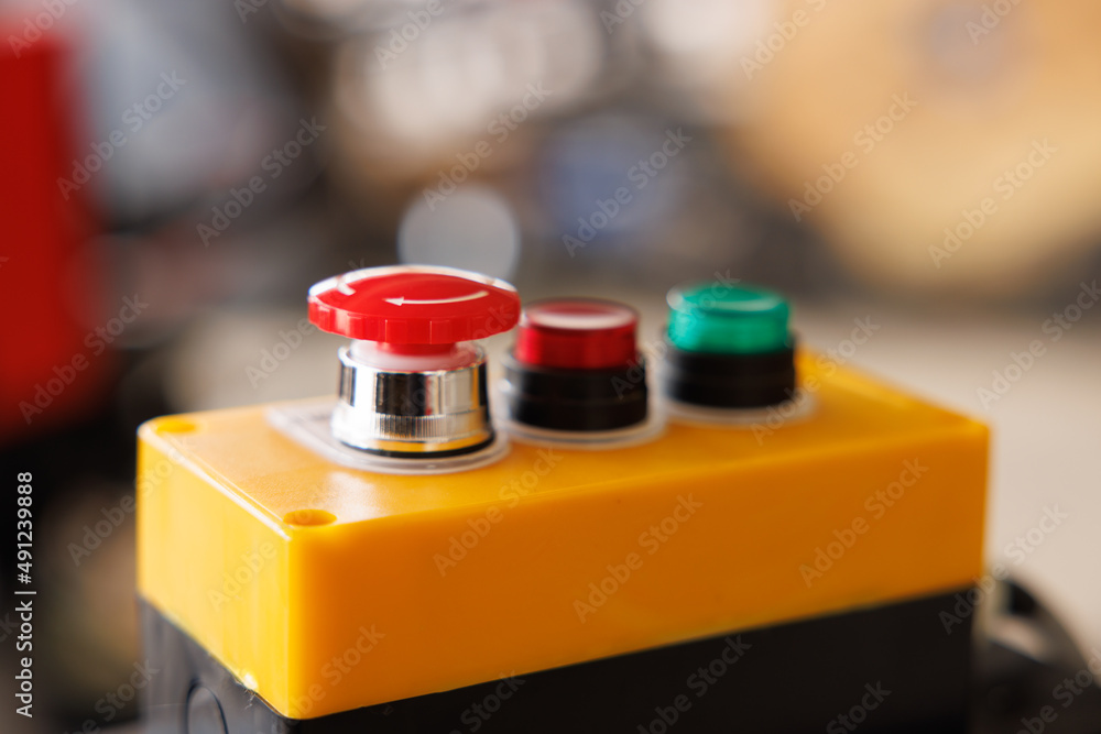 emergency stop button with blur background in industry factory. start ...