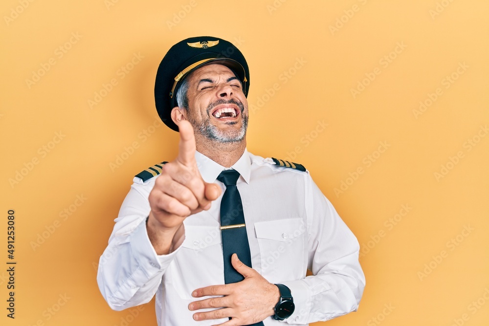 Handsome middle age man with grey hair wearing airplane pilot uniform ...