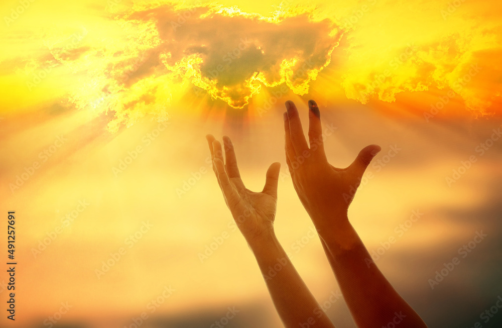 God's helping hand on sunset background. Stock Photo | Adobe Stock