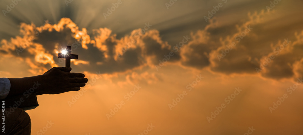 Human hands holding cross Stock Photo | Adobe Stock