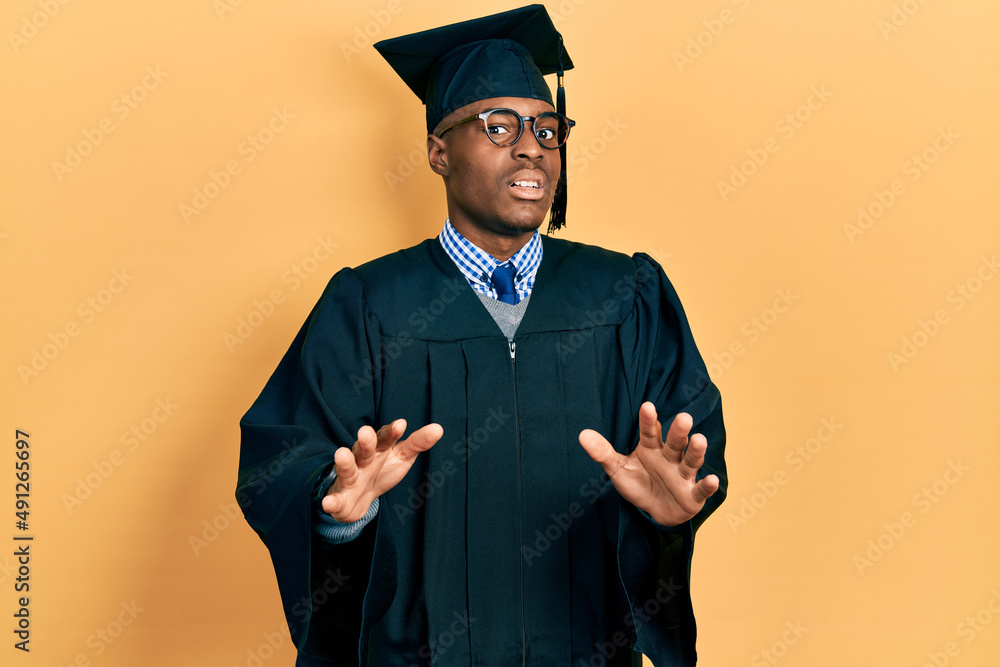 Young african american man wearing graduation cap and ceremony robe ...