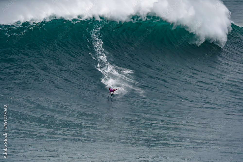 Professional surfer falling into a giant wave Stock Photo | Adobe Stock