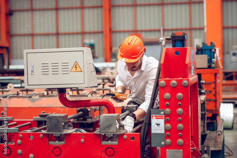 Factory worker checking electrical machine process at industrial ...