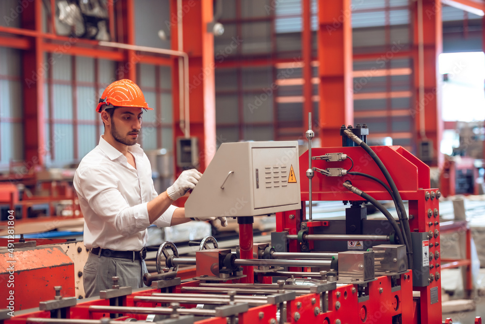 Factory worker checking electrical machine process at industrial ...