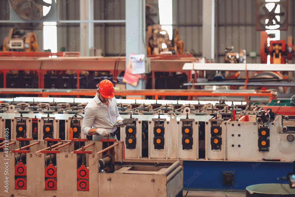 Factory worker checking electrical machine process at industrial ...