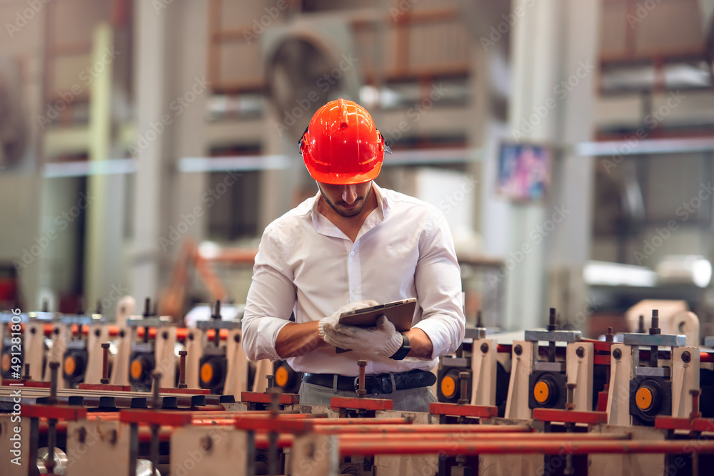 Factory worker checking electrical machine process at industrial ...