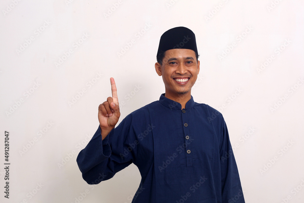 Portrait of Asian man standing and showing one finger. Isolated on ...