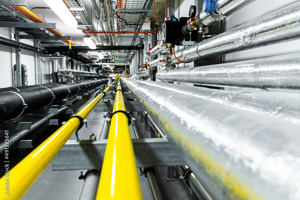 Gas and waste pipelines in the underground premises of the factory ...