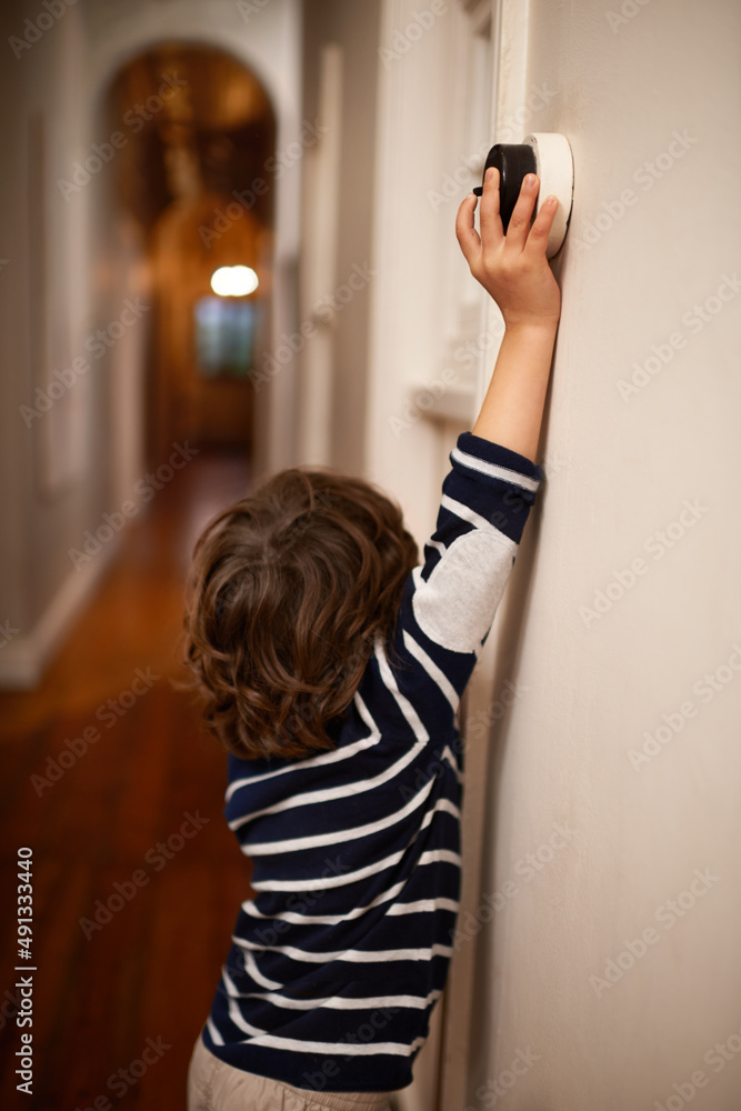 Saving the planet one switch at a time. A cropped shot of a little boy ...