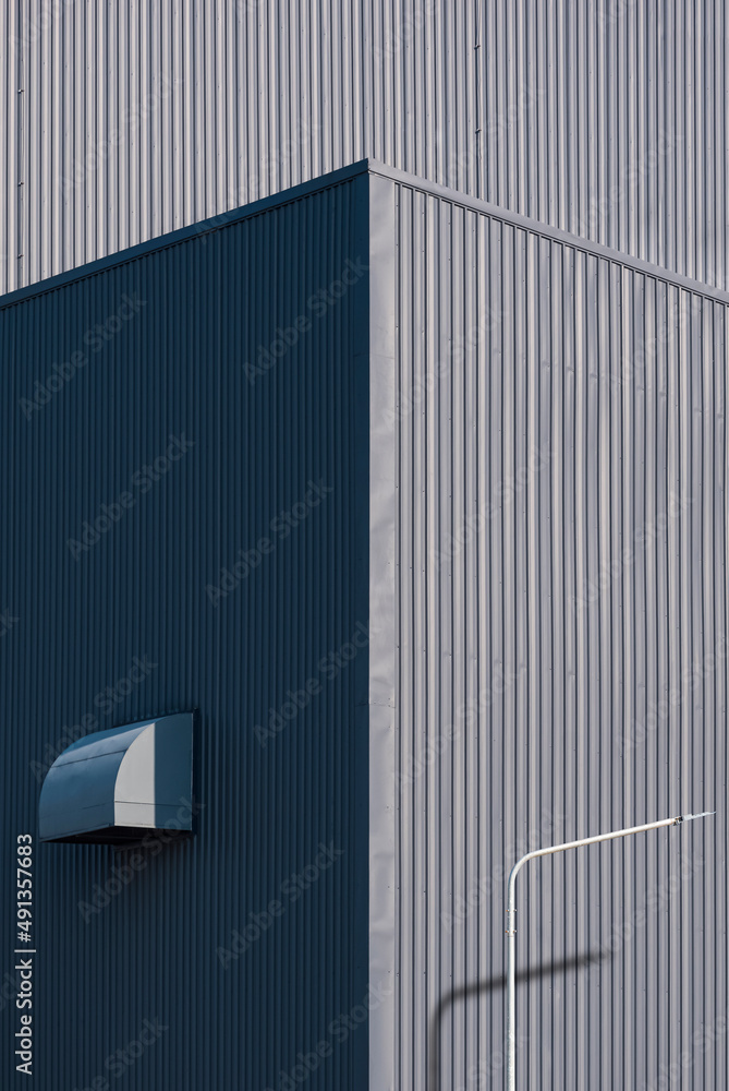 Sunlight and shadow on surface of street light post with air duct ...