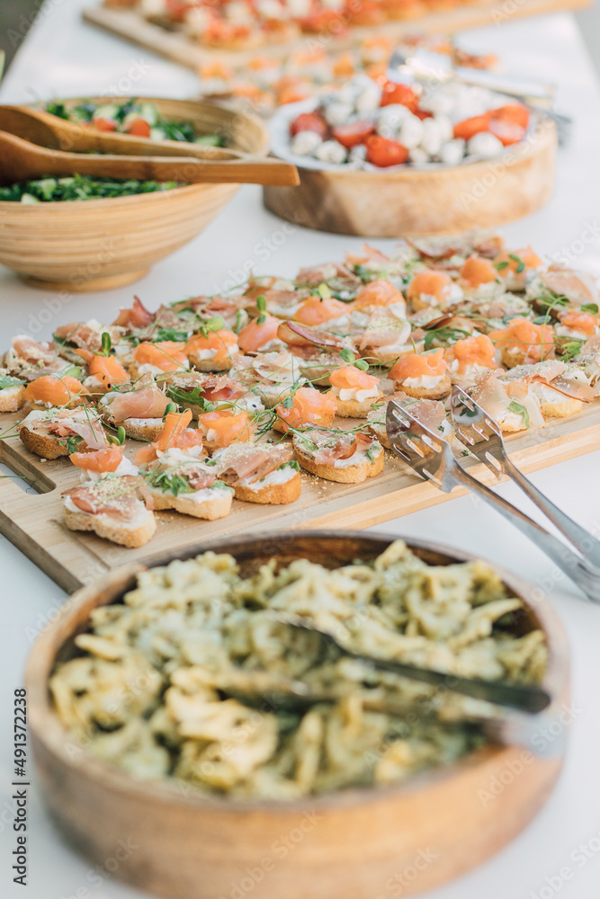 Variety of Mediterranean starter foods: bruschetta with smoked salmon ...