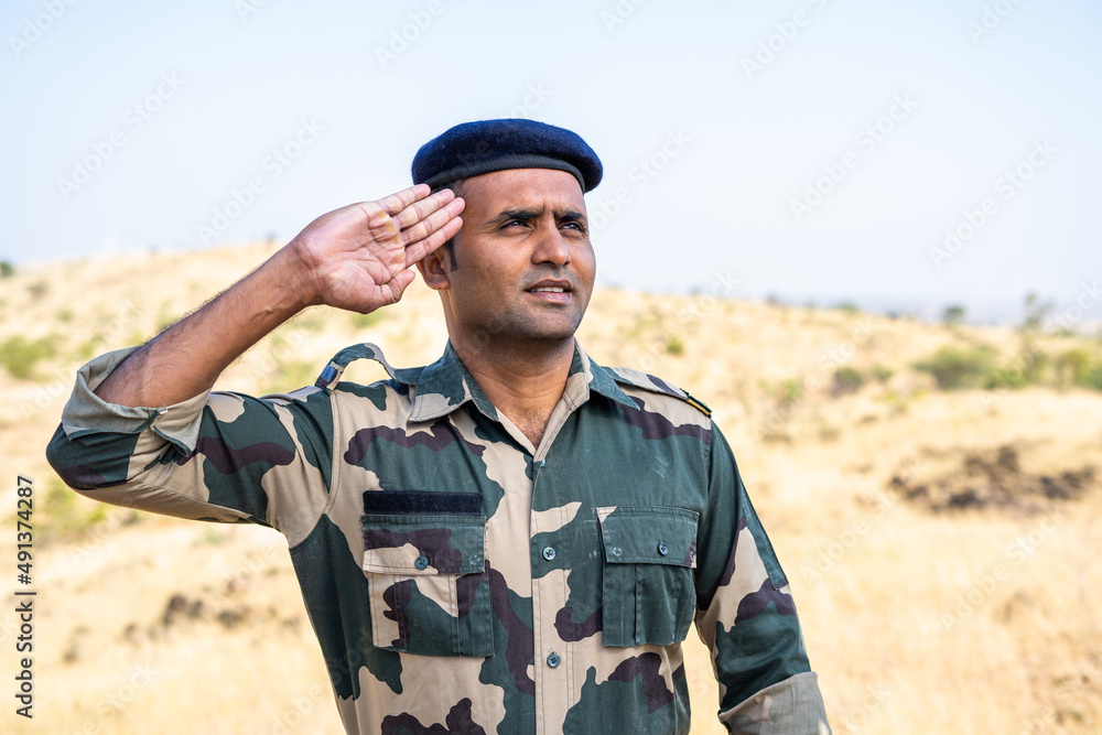 Proud Indian army soldier saluting by looking above - concept of ...