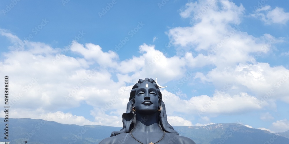 Adiyogi shiva with blue sky background. Stock Photo | Adobe Stock