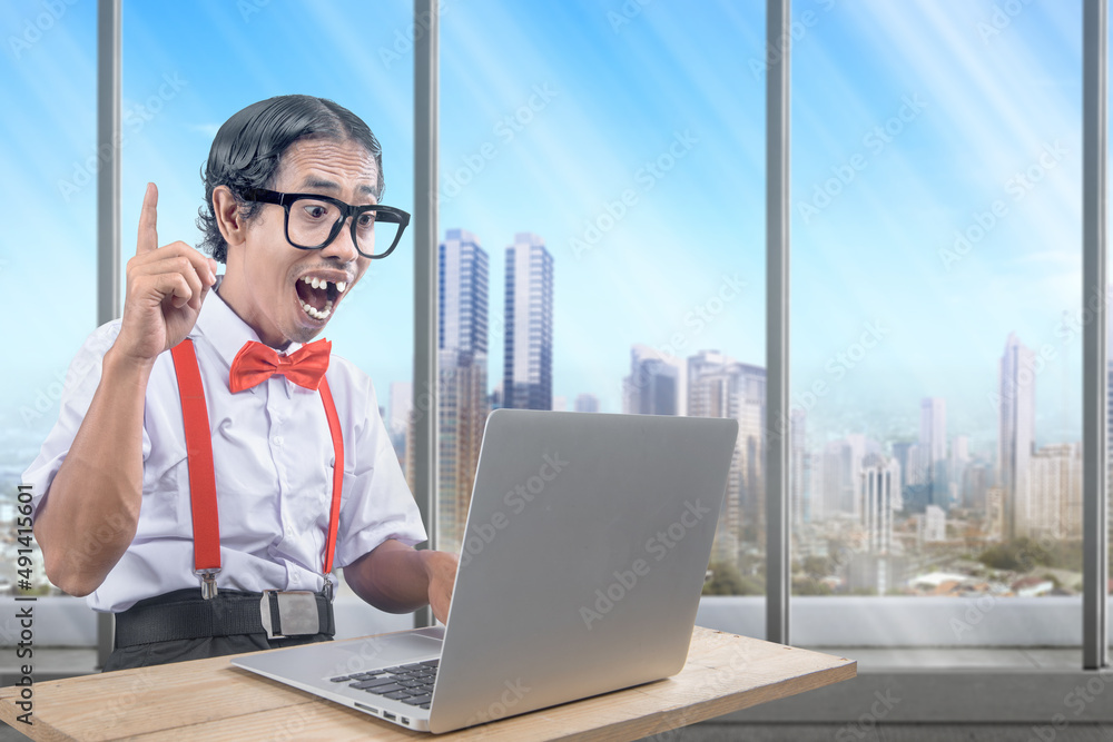 Asian nerd with an ugly face using laptop inside the room Stock Photo ...
