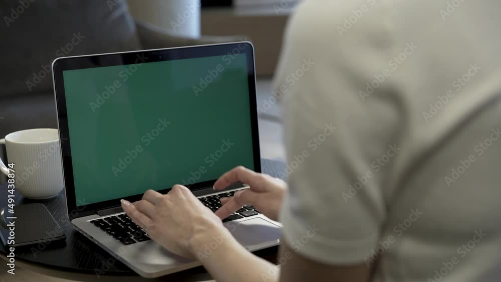 Over the shoulder shot of a business woman working in office interior ...