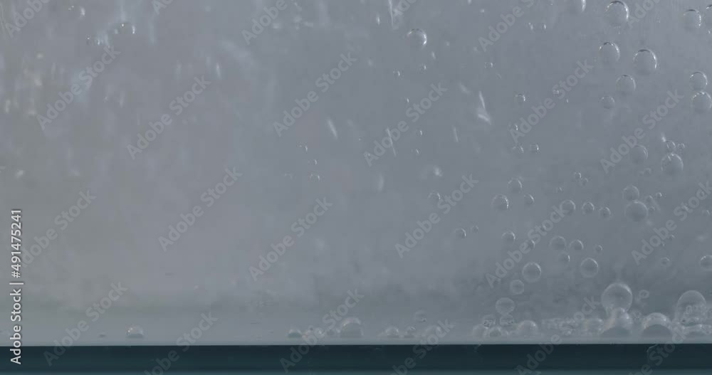 fizzy soda gets filled into full water tank or aquarium shot at 60 fps ...