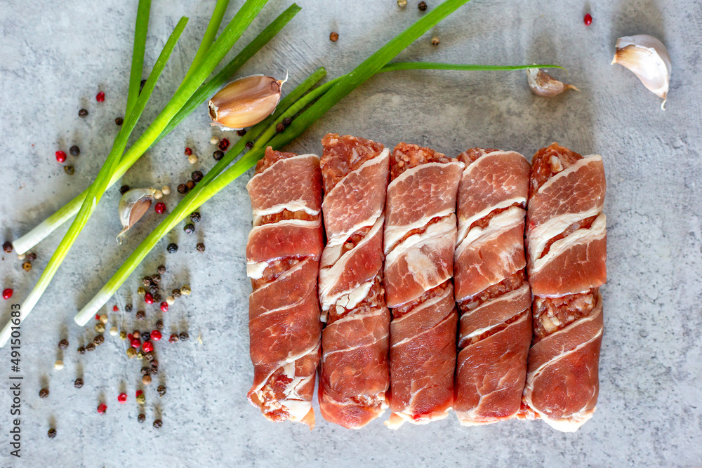 Chevapchichi on the grey background, top view. Minced meat wrapped in ...