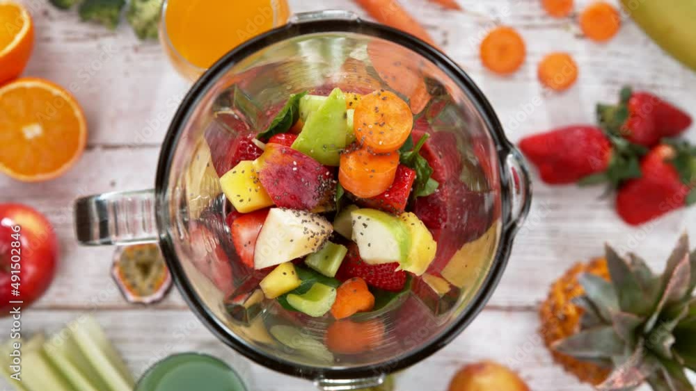 Fresh fruit and vegetables smoothie blended in blender, top view ...