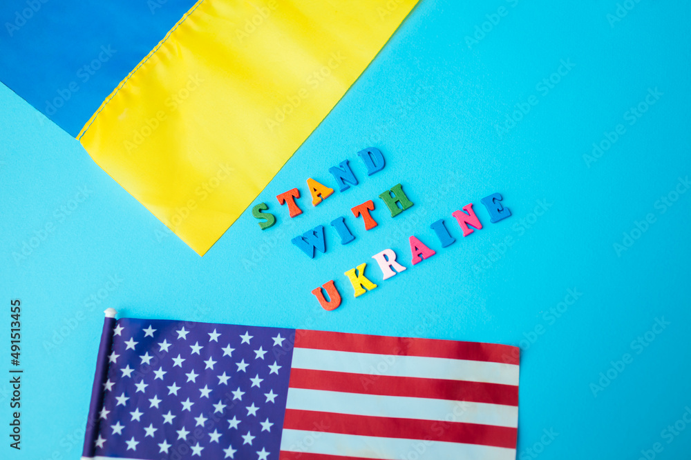 Stand with Ukraine slogan. Ukrainian and american flags during war ...