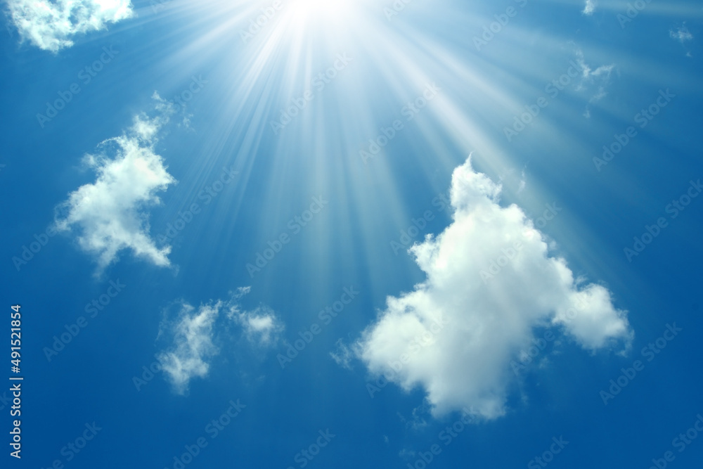 A blue sky with sun and clouds background. Shining sun on blue sky with ...