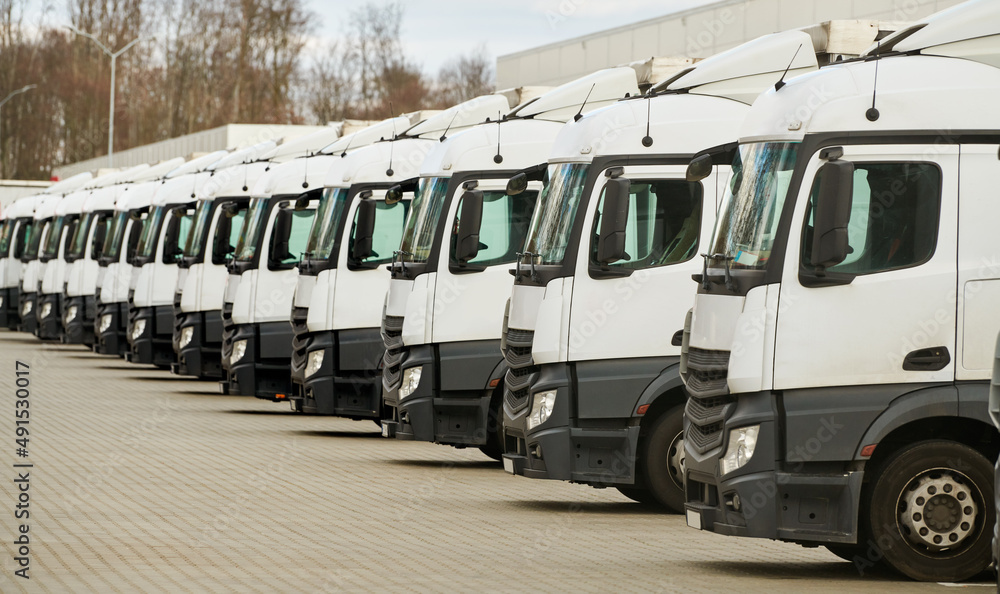 Fleet of commercial lorry trucks in row. Logistics and transportation ...