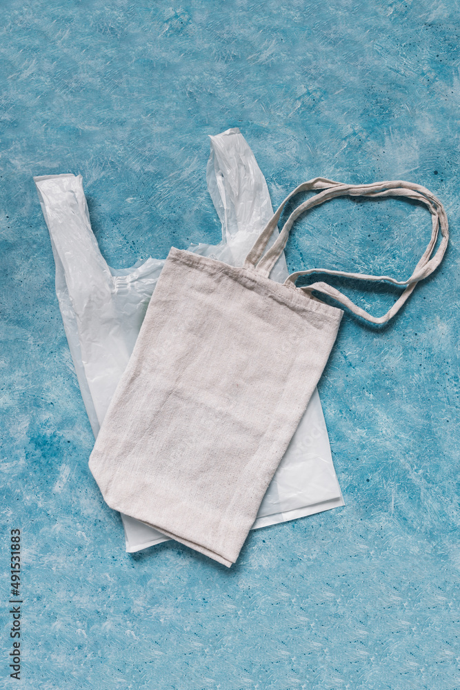 single use plastic bag next to reusable canvas one, plastic pollution ...