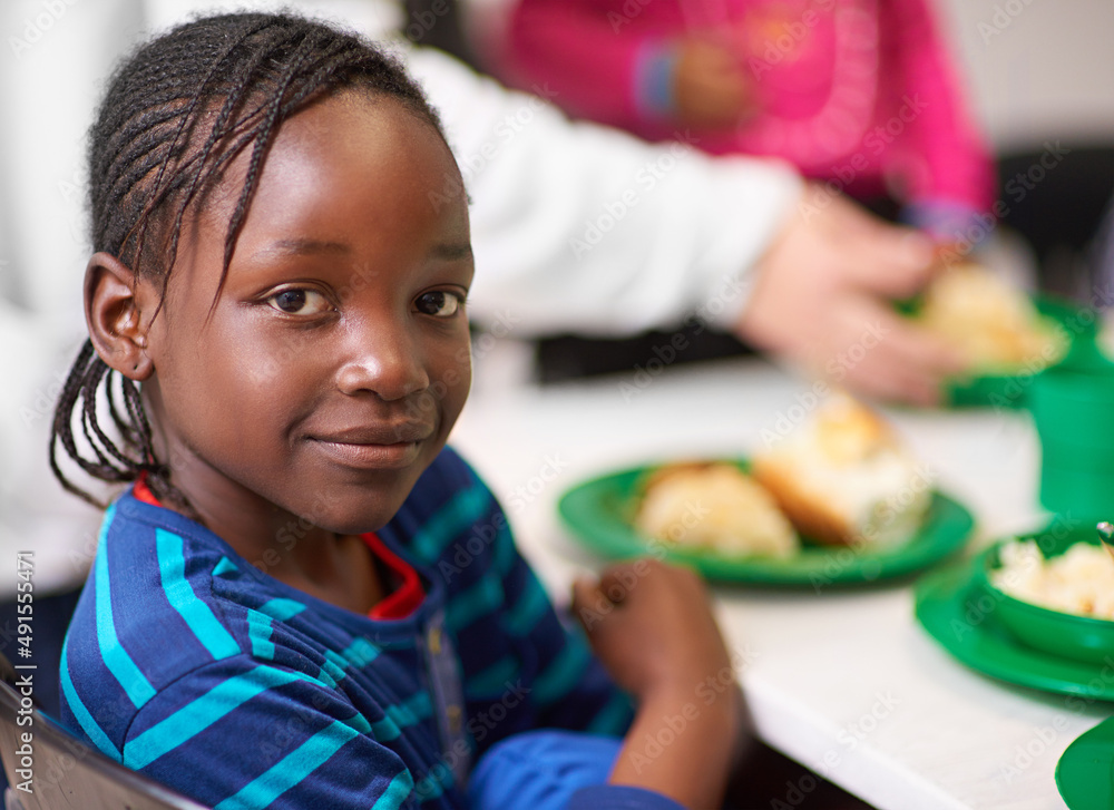 No child should be hungry. Portrait of a little girl sitting at a ...