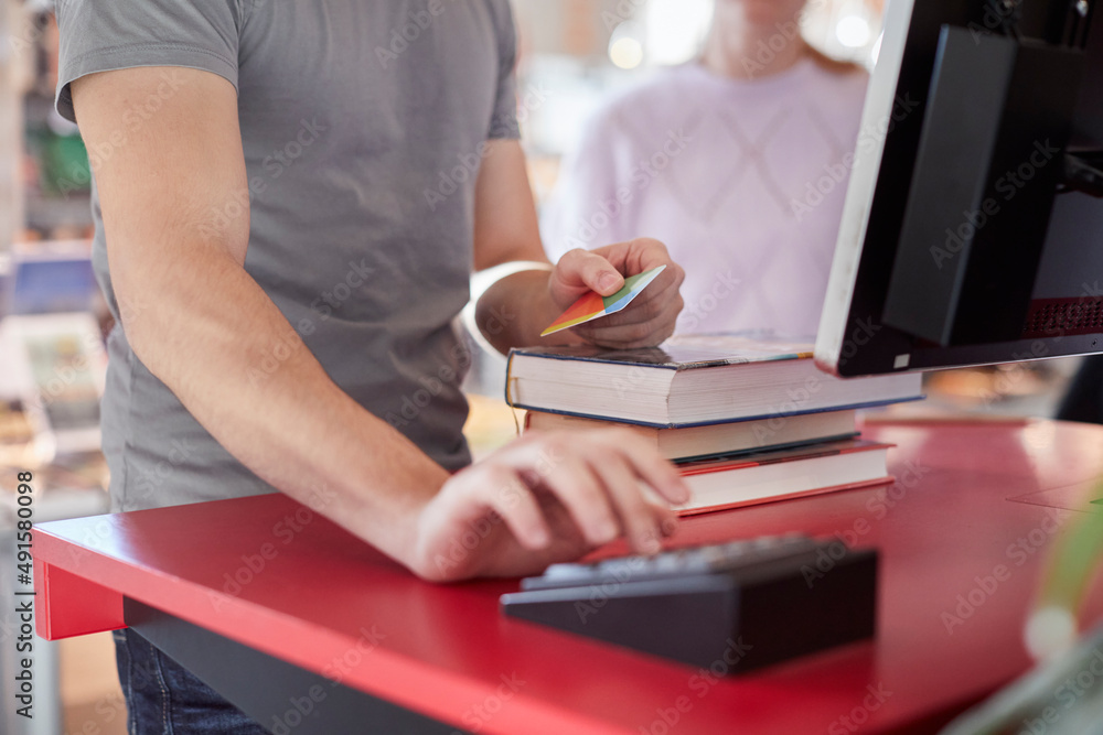 Student borrowing books with library card Stock Photo | Adobe Stock